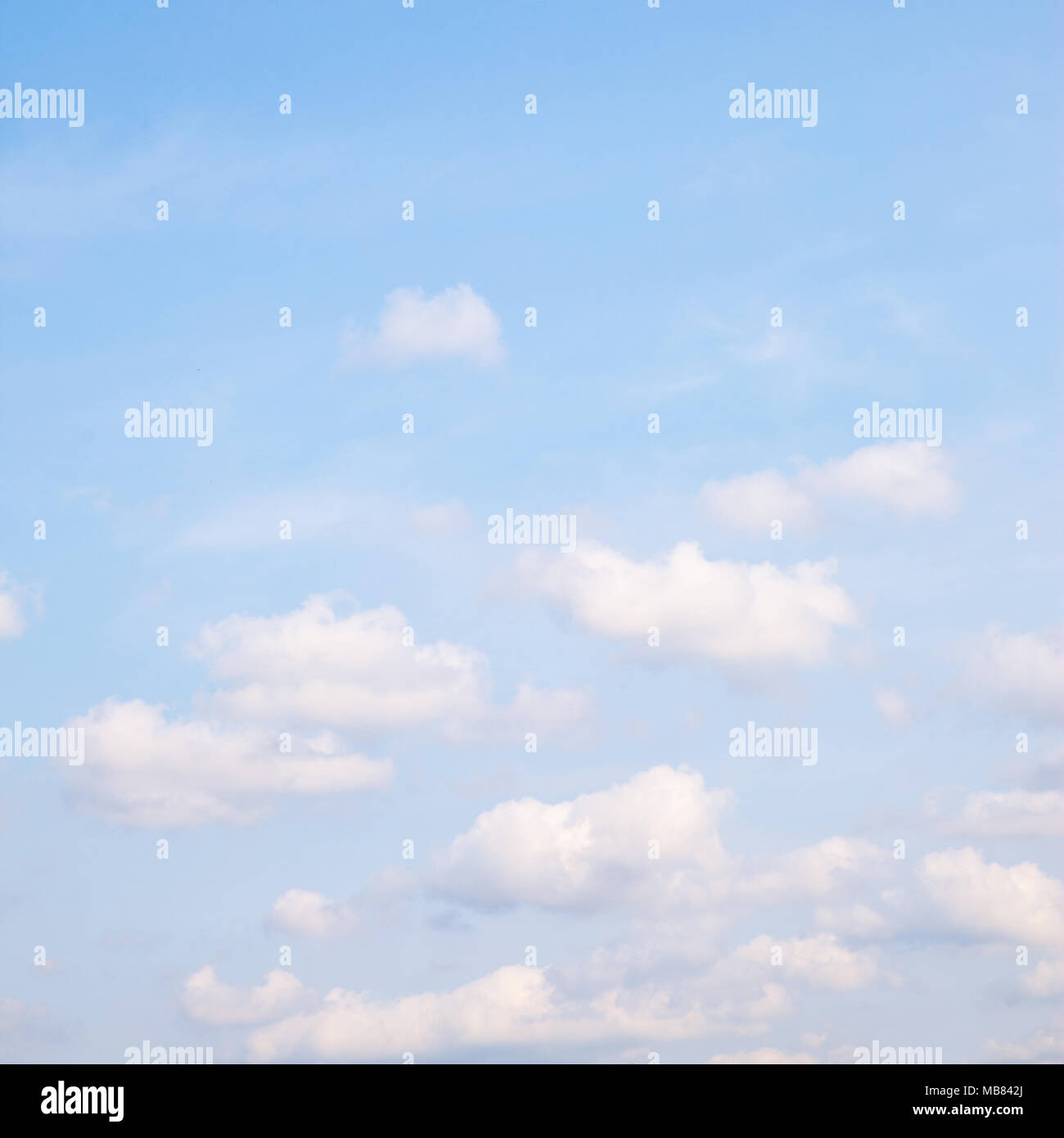 Light blue spring sky with clouds - background, space for your own text ...
