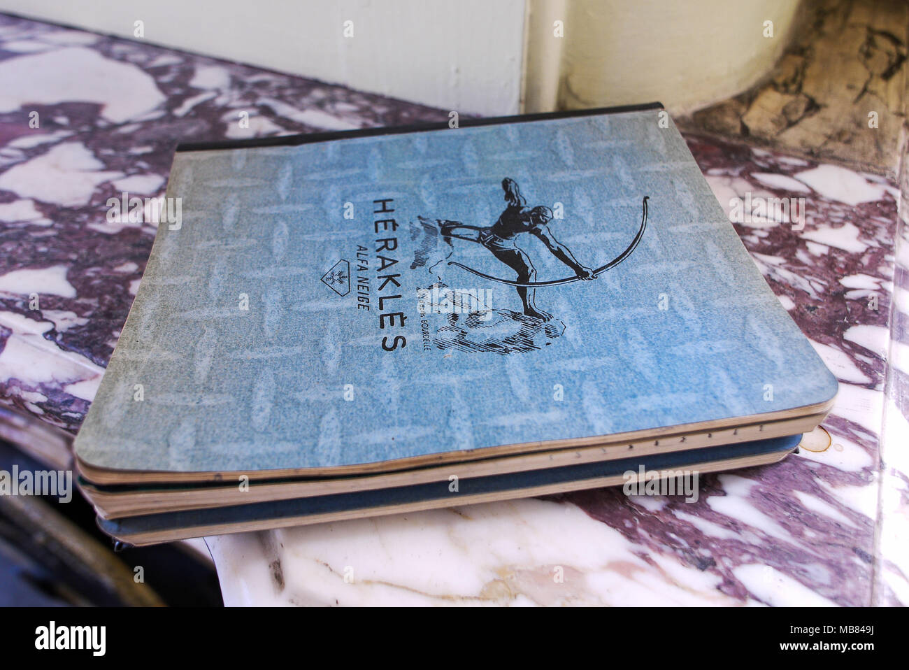 Old exercise schoolbooks displayed on a table in a classroom, Lyon ...
