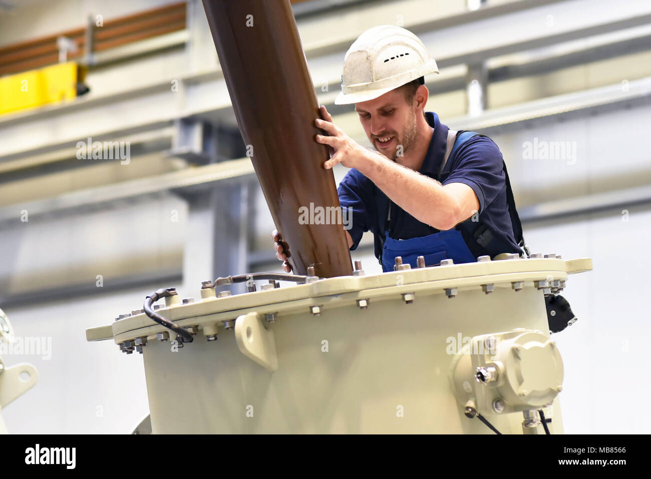 operator installs a transformer in an industrial plant in mechanical ...