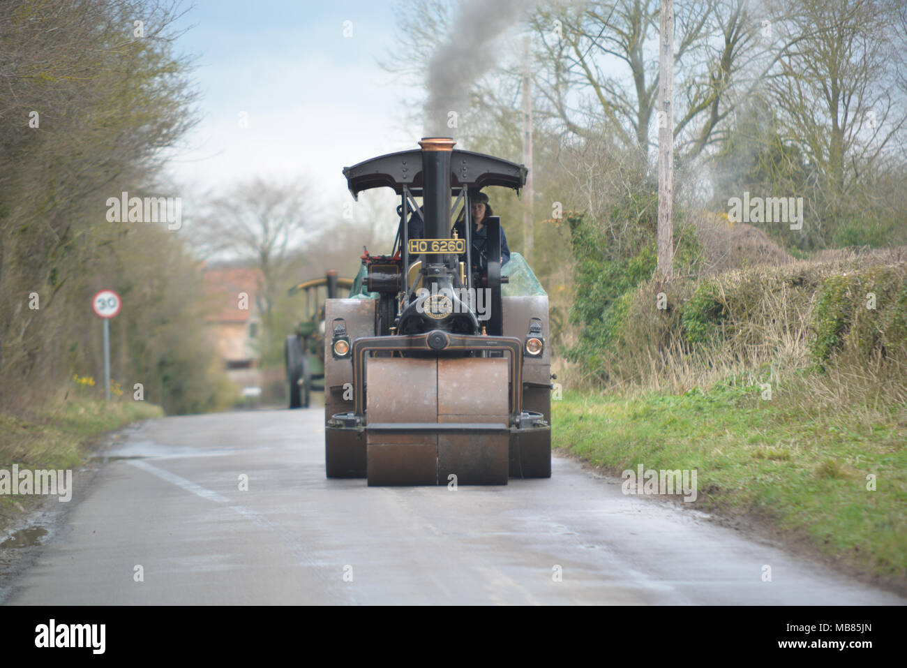 Steam rollers and traction engines in a vintage road works scene, steam ...
