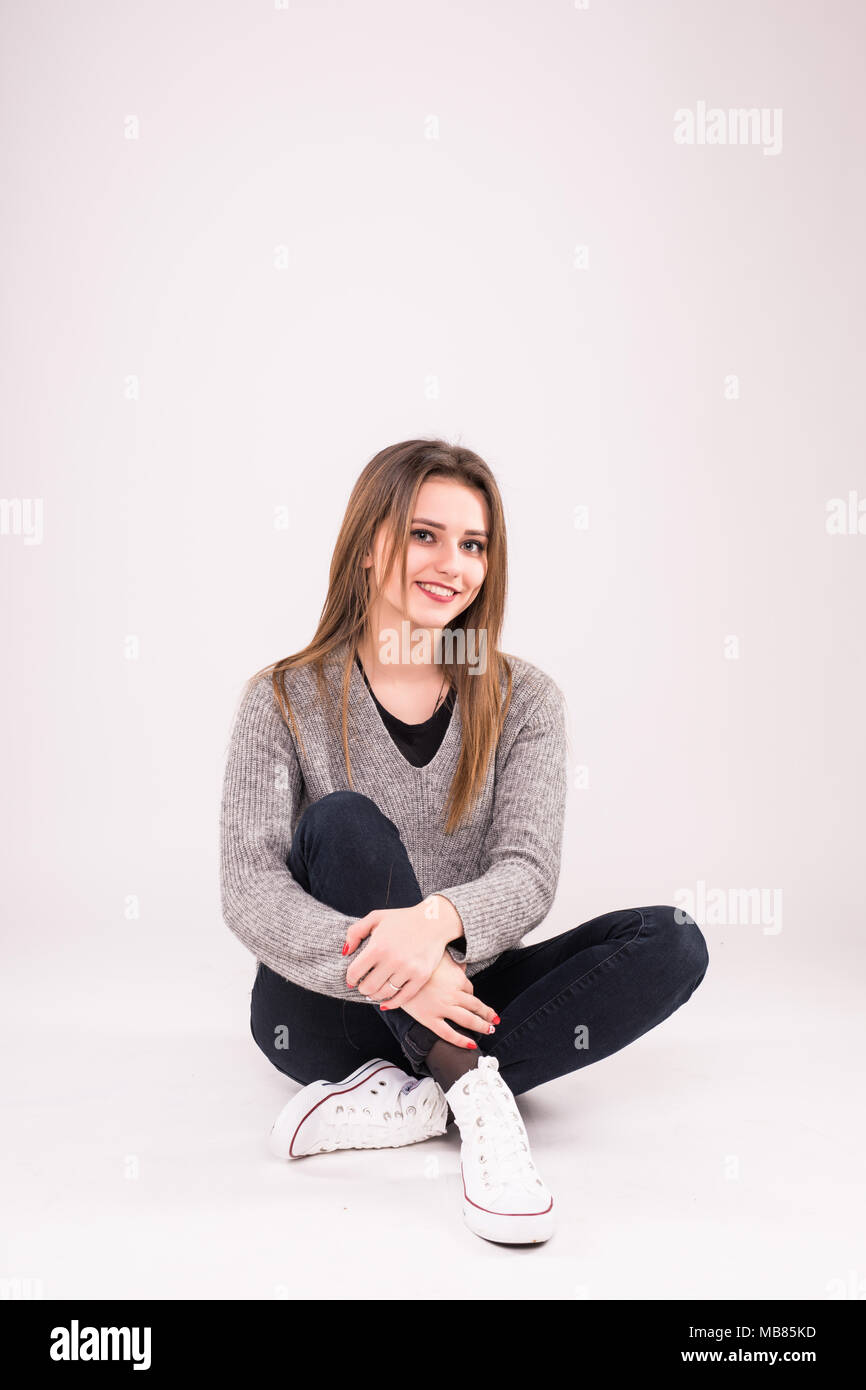 Happy student sitting on the floor isolated Stock Photo - Alamy