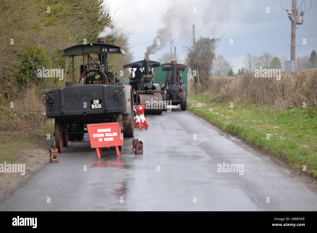 Steam rollers and traction engines in a vintage road works scene, steam ...