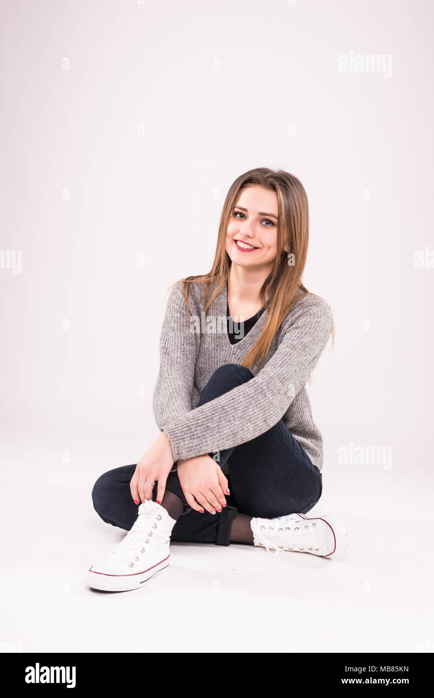 Happy student sitting on the floor isolated Stock Photo - Alamy