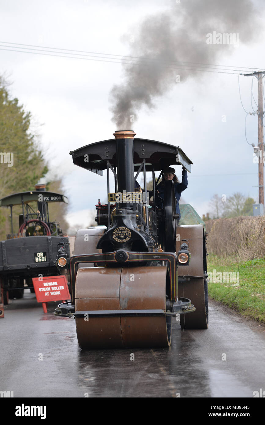 Steam rollers and traction engines in a vintage road works scene, steam ...