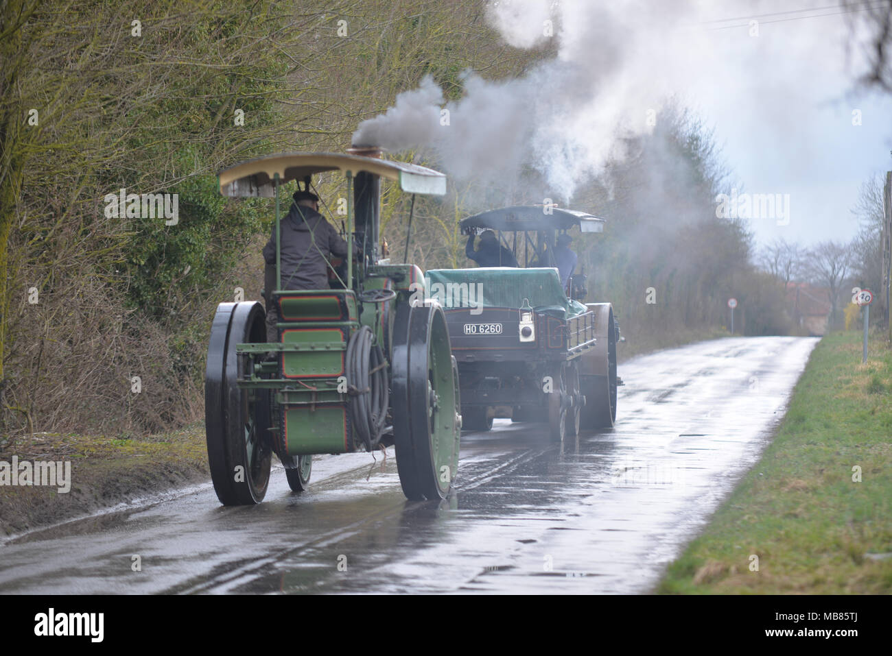 Steam rollers and traction engines in a vintage road works scene, steam ...