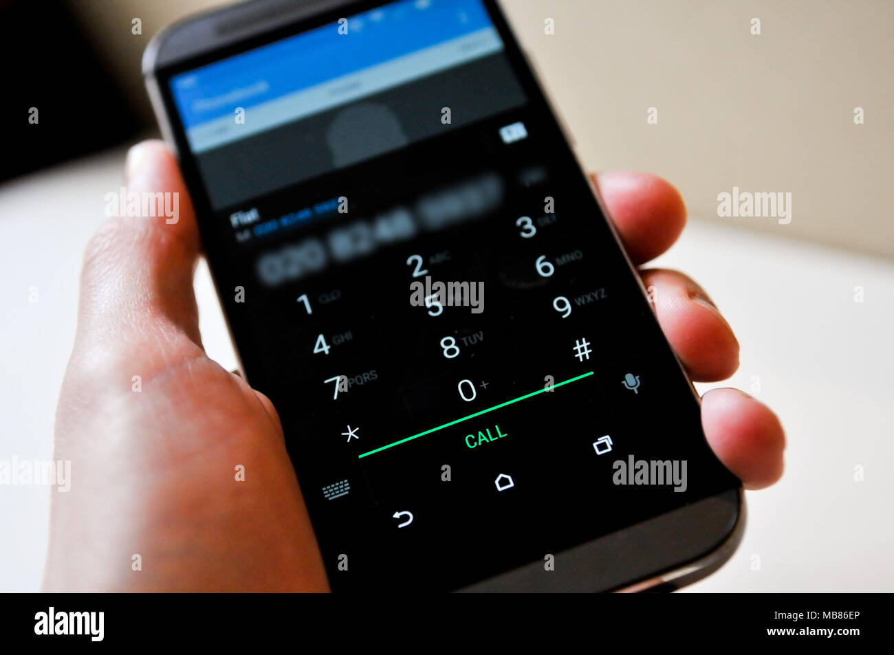 Hand holding a mobile phone to make a phone call Stock Photo - Alamy