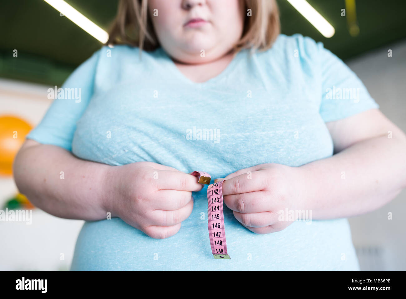 Overweight woman measuring waist hi-res stock photography and images ...