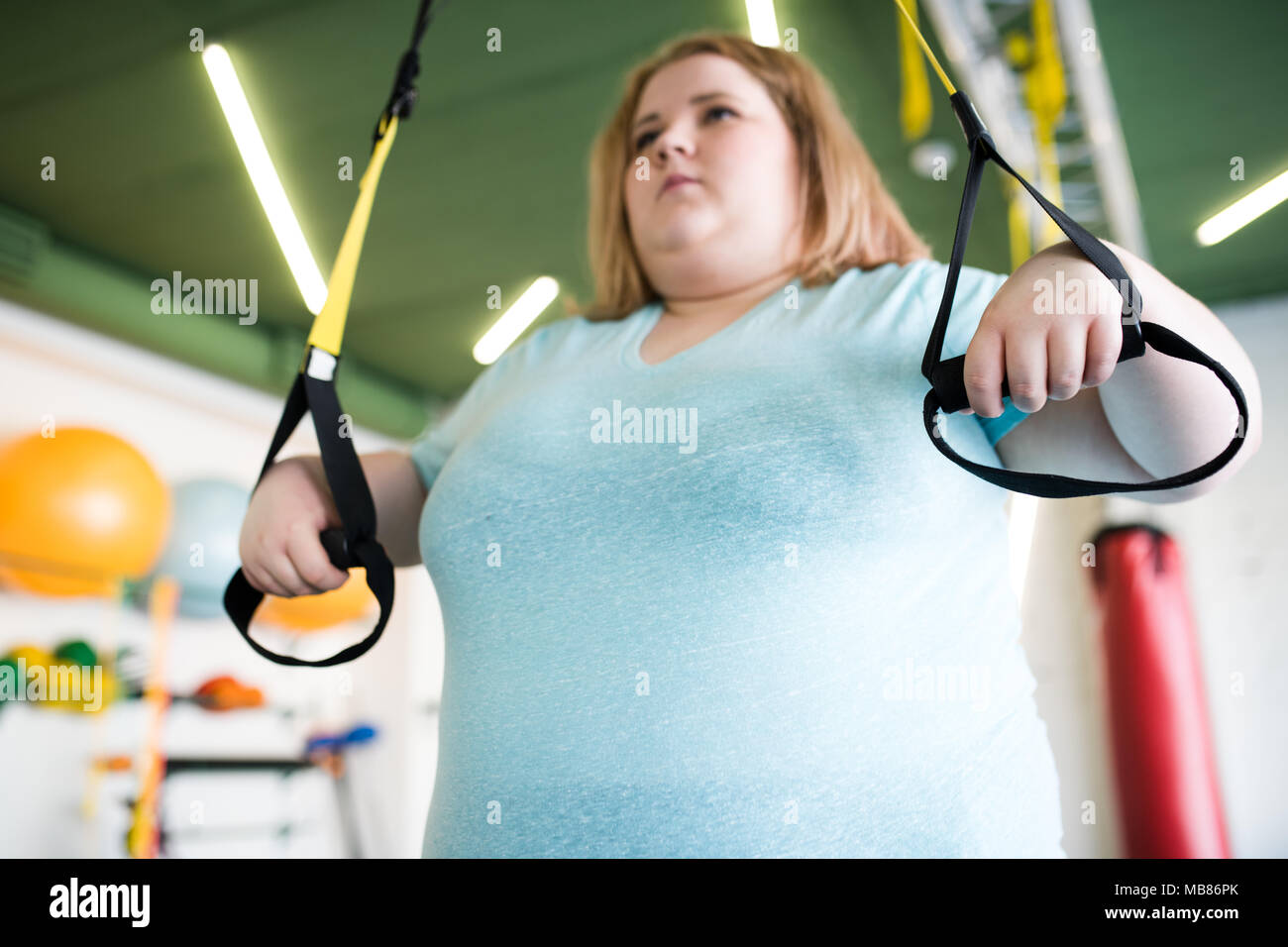 Overweight Woman Exercising in Gym Stock Photo - Alamy