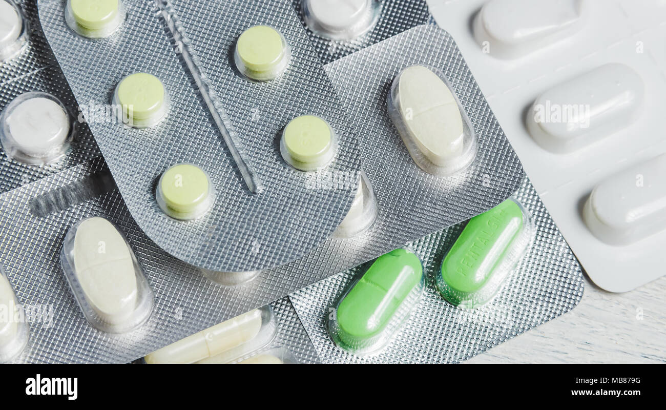Set of Various Tablets and Capsules in Blisters on White Wooden ...