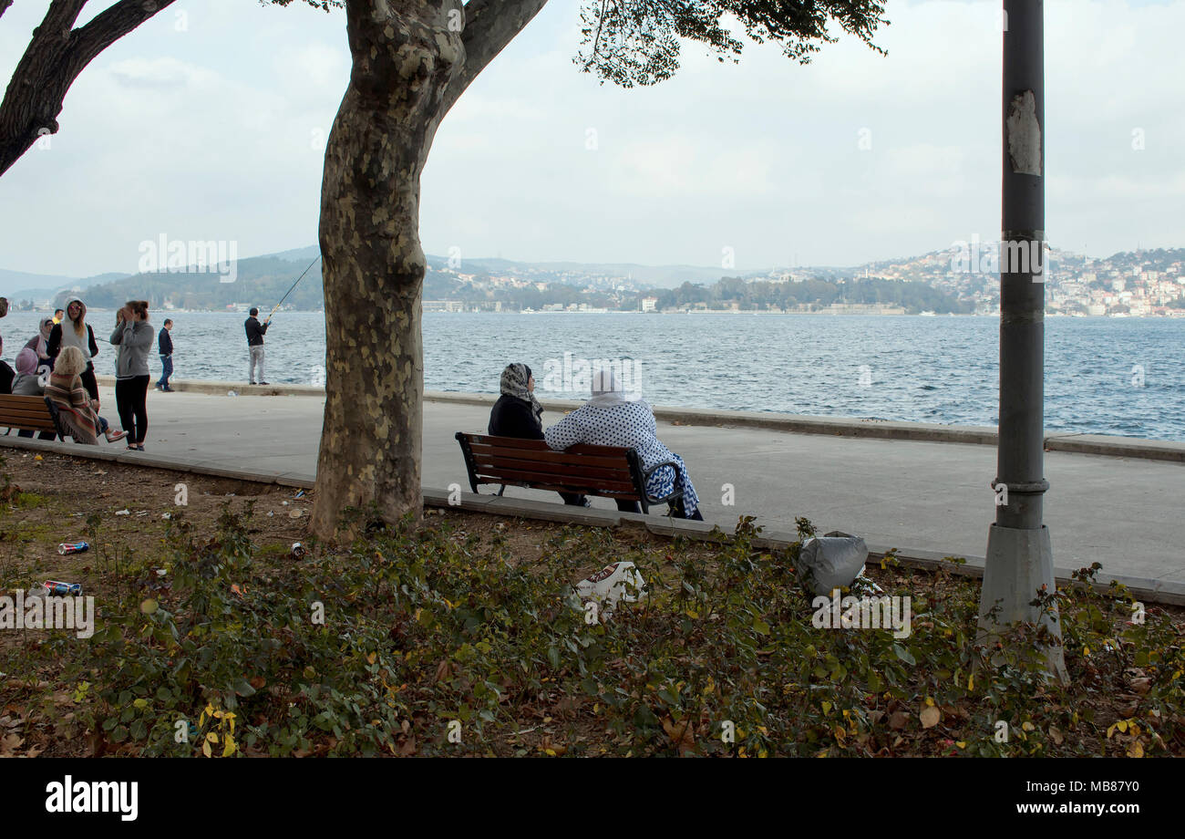 Women sit on benches by Bosphorus strait in Istanbul Stock Photo - Alamy
