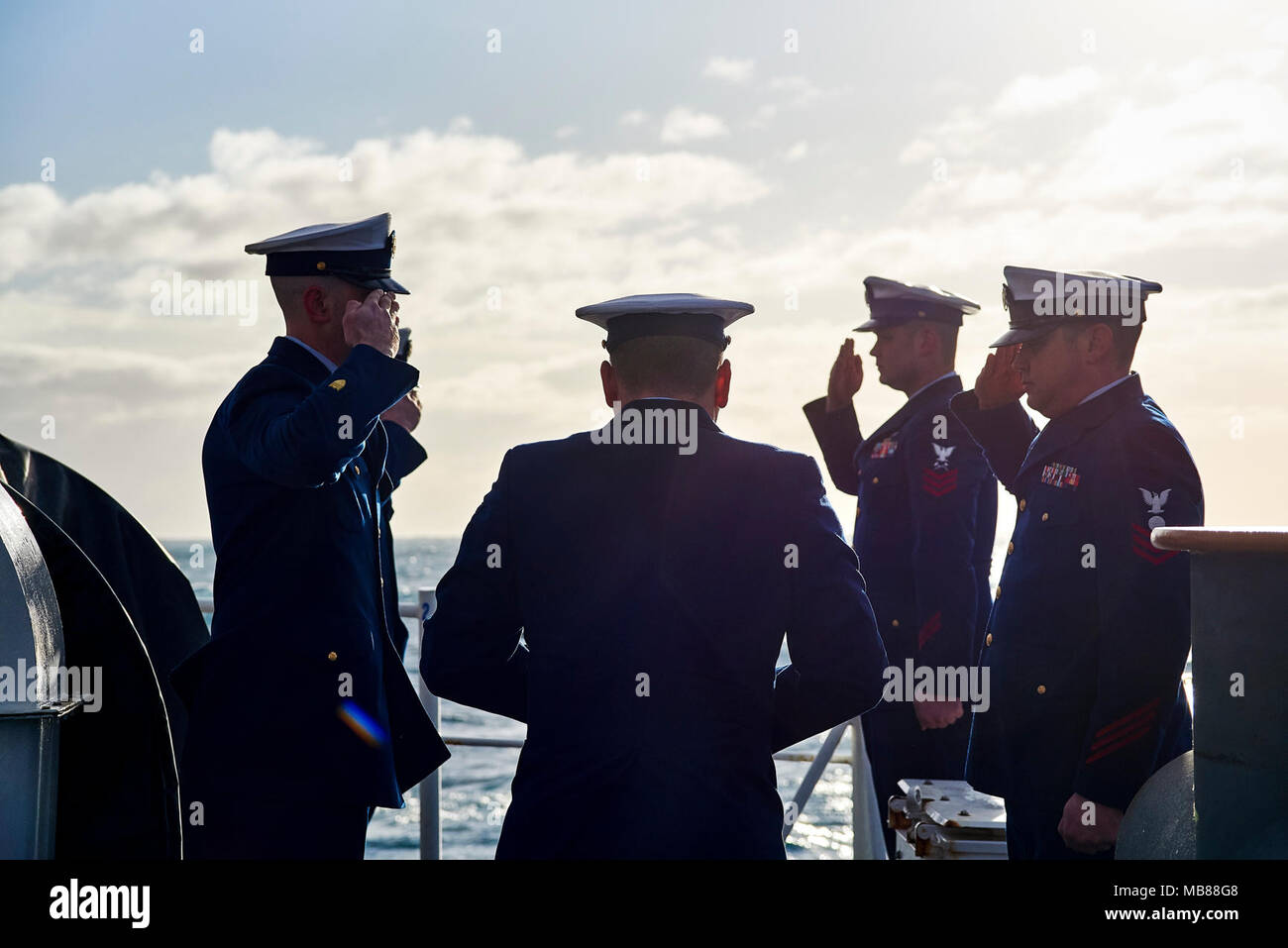 Members aboard the Coast Guard Cutter SPAR conduct a burial at sea near ...