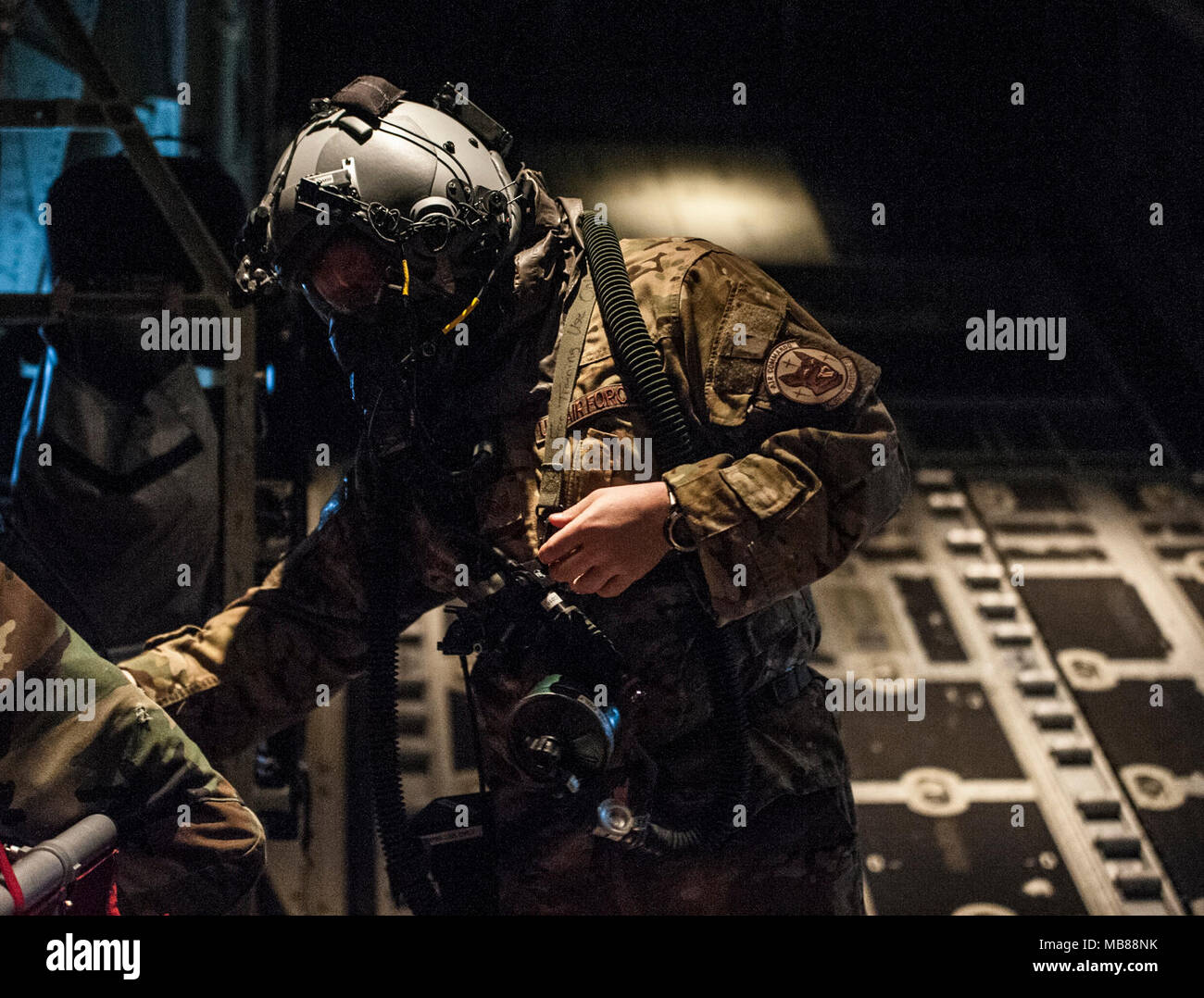 A U.S. Air Force 17th Special Operations Squadron loadmaster puts on ...