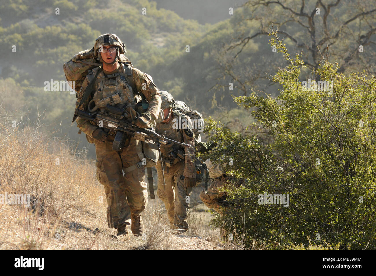 A 5th Battalion, 20th Infantry Regiment, Soldier rucks up a hill during ...