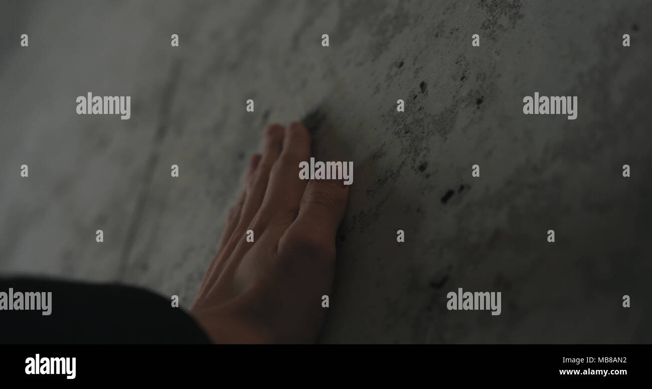 handheld of man hand touching concrete wall, wide photo Stock Photo - Alamy