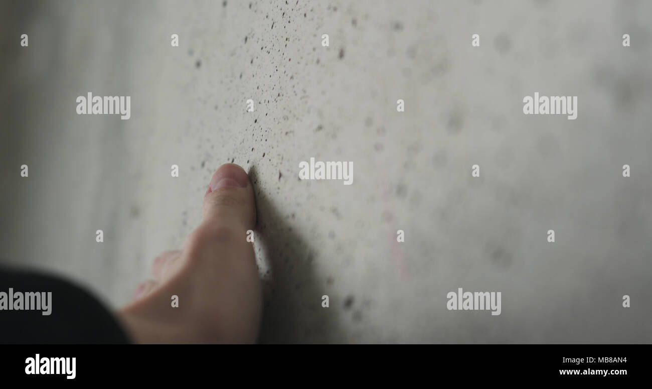 handheld of man hand touching concrete wall, wide photo Stock Photo - Alamy
