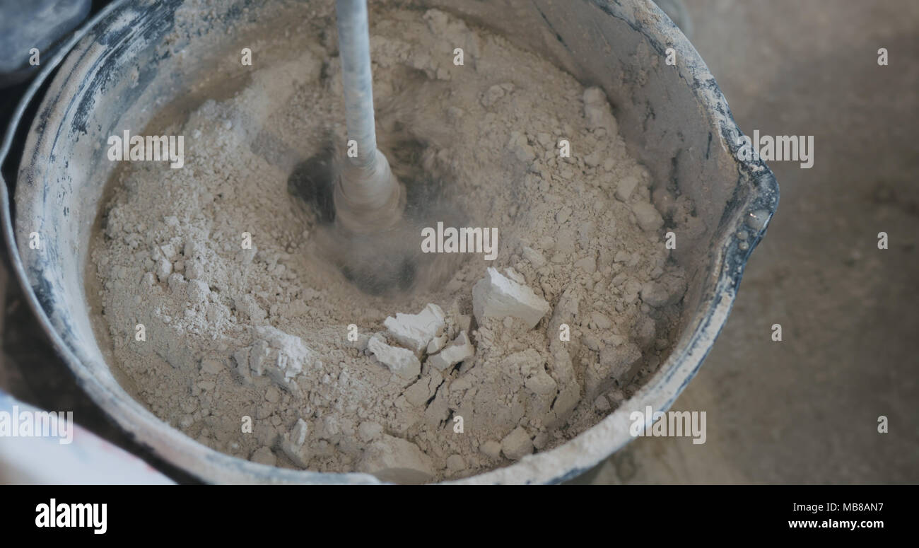 mixing concrete plaster with electric mixer, wide photo Stock Photo - Alamy