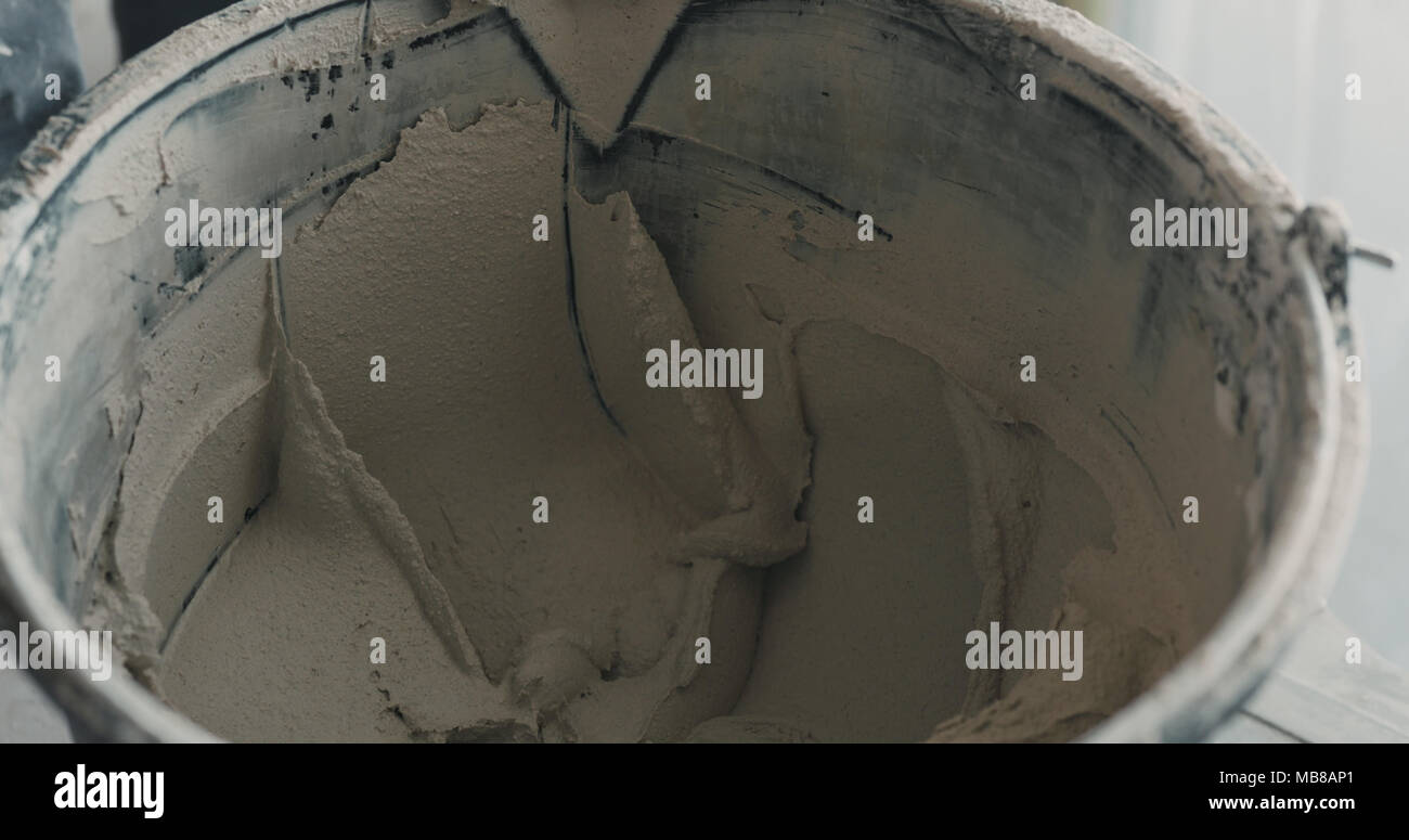 plaster inside bucket for wall renovation, wide photo Stock Photo - Alamy