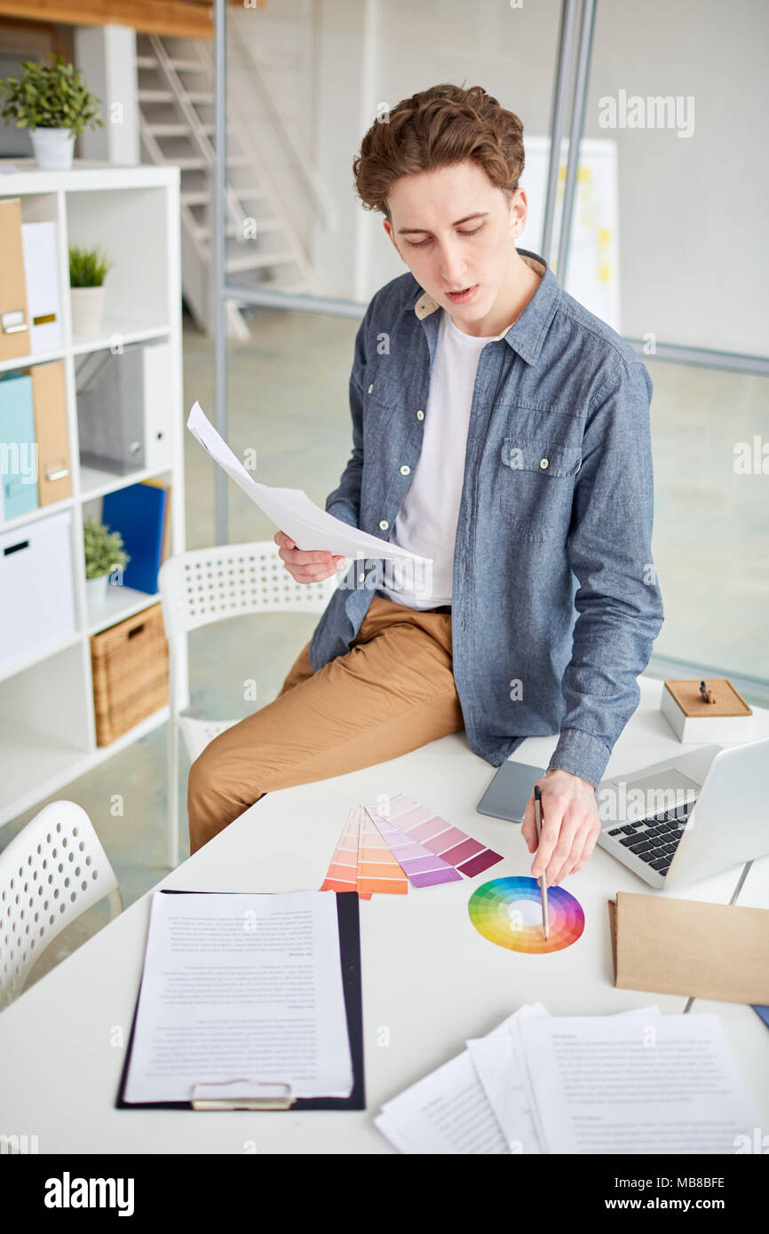 Male interior designer at office working with color swatch Stock Photo ...