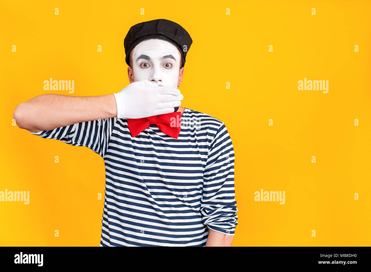 Don't say anymore. Mime man closed mouth his hands. Emotions and ...
