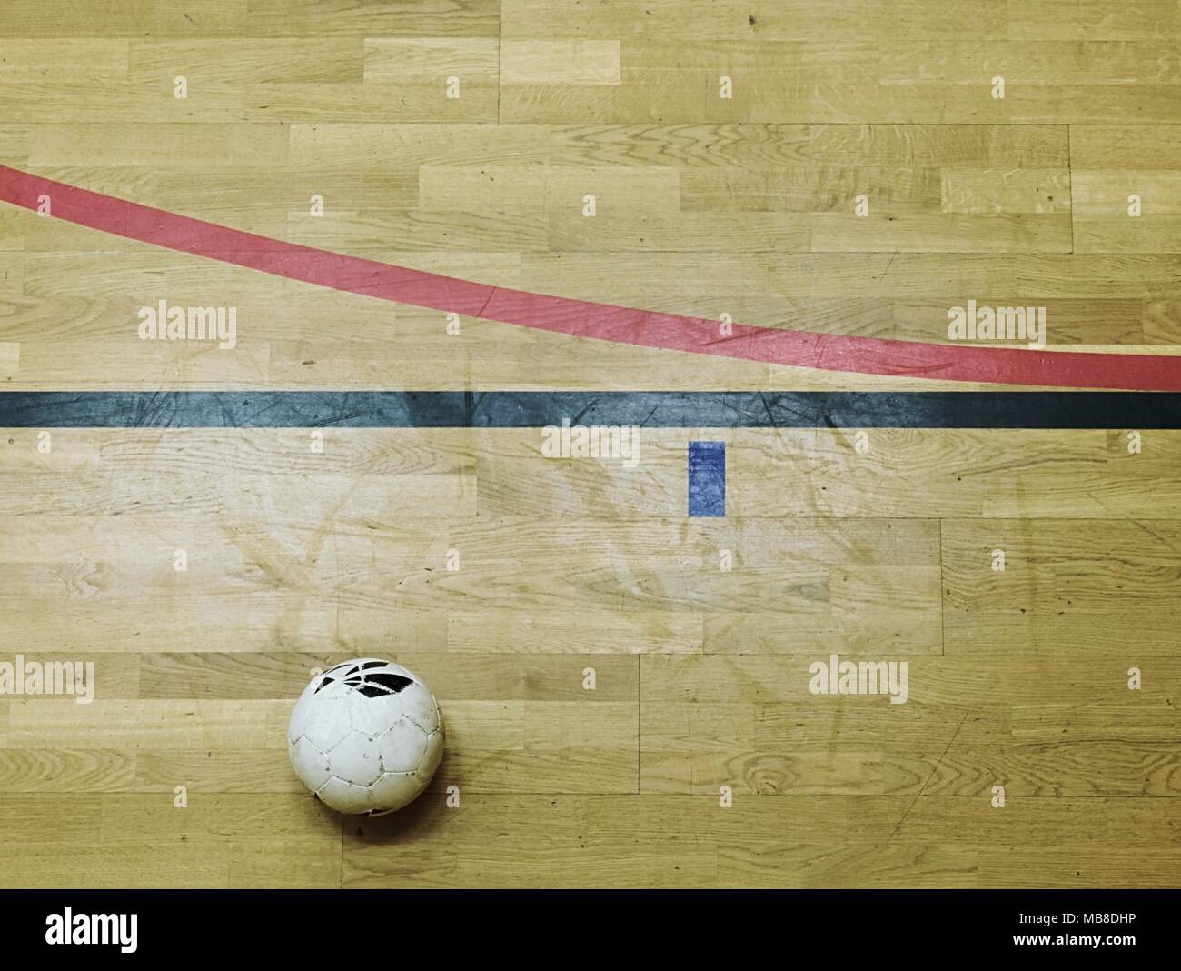 Futsal ball and red and black lines on hardwood sporting floor. Renewal ...