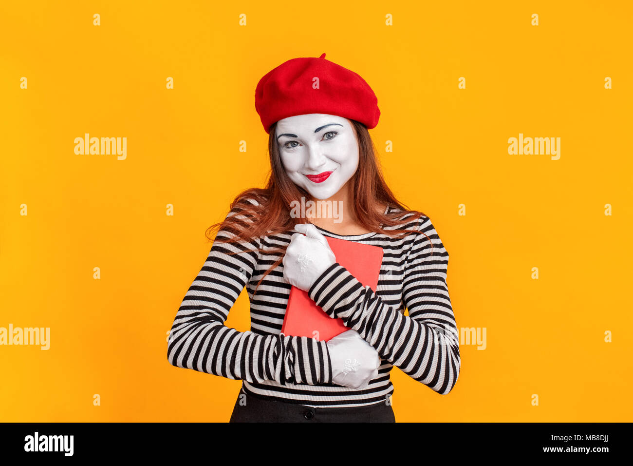 Portrait of cute mime woman hug red big book. Emotions and feelings ...