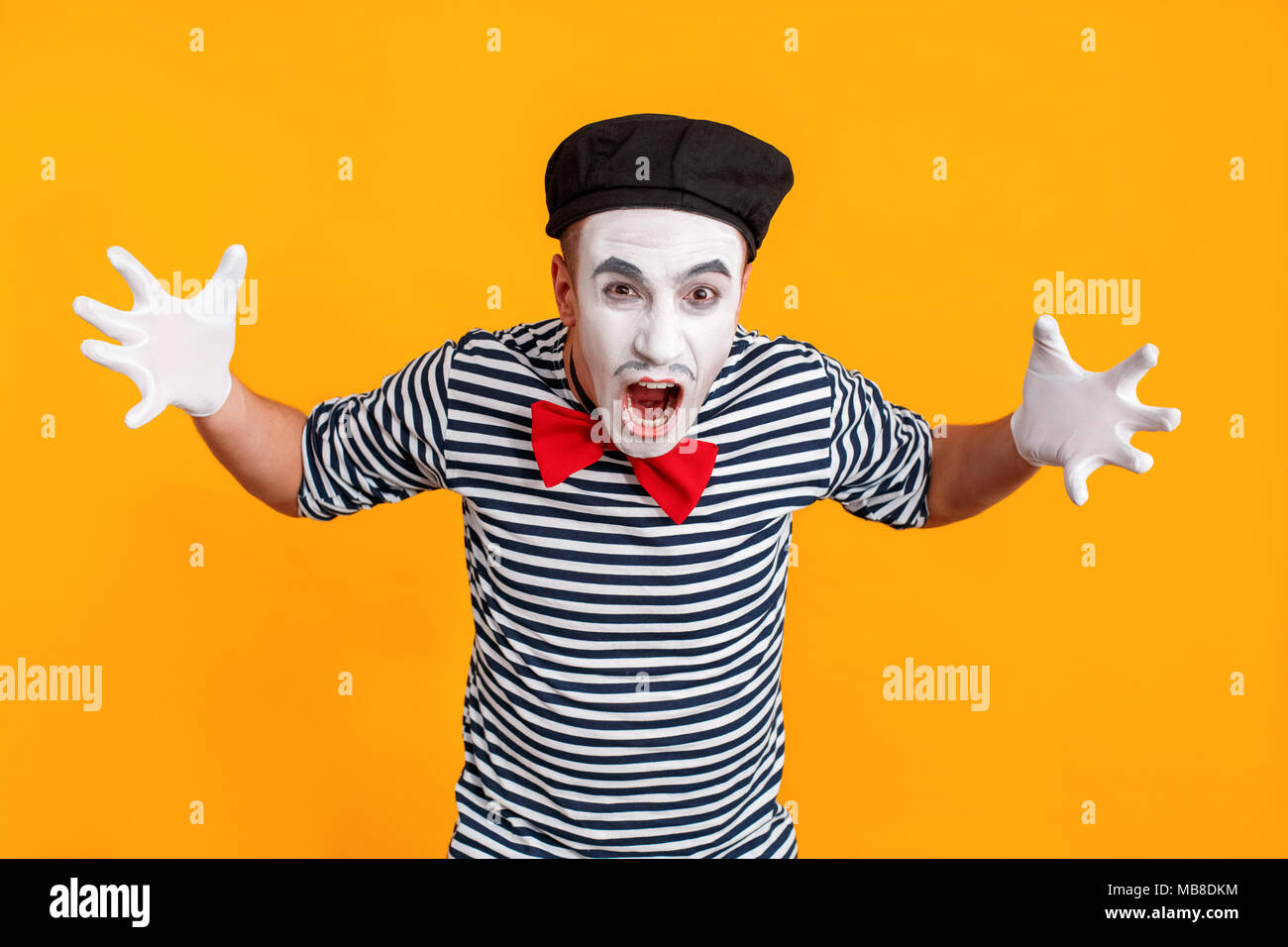 Anger concept. Mime man looking angry at camera and roar, shout ...