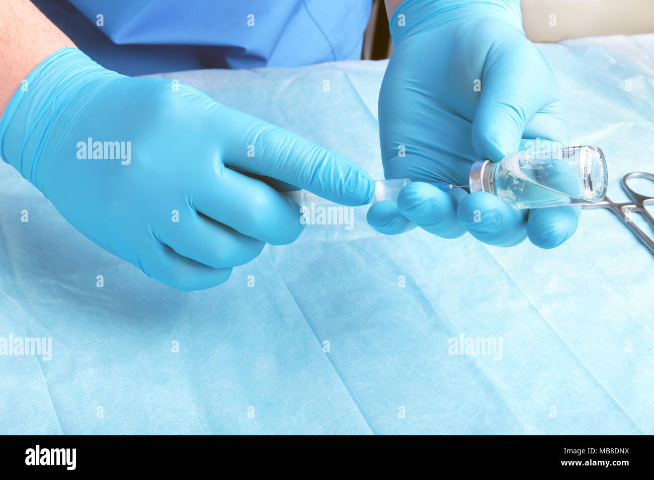 Syringe, medical injection, bottle, ampule in hand, palm or fingers ...