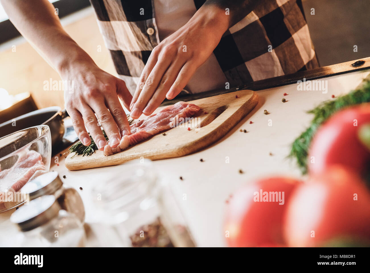 Man cooks meat, marinades in spices. Indoor, kitchen home interior ...