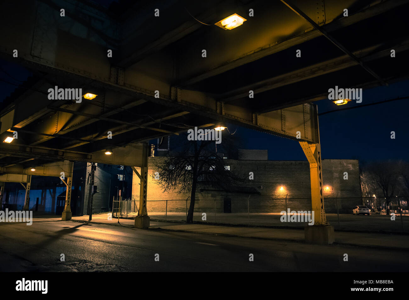 Dark and eerie Chicago urban city street night scenery with elevated ...