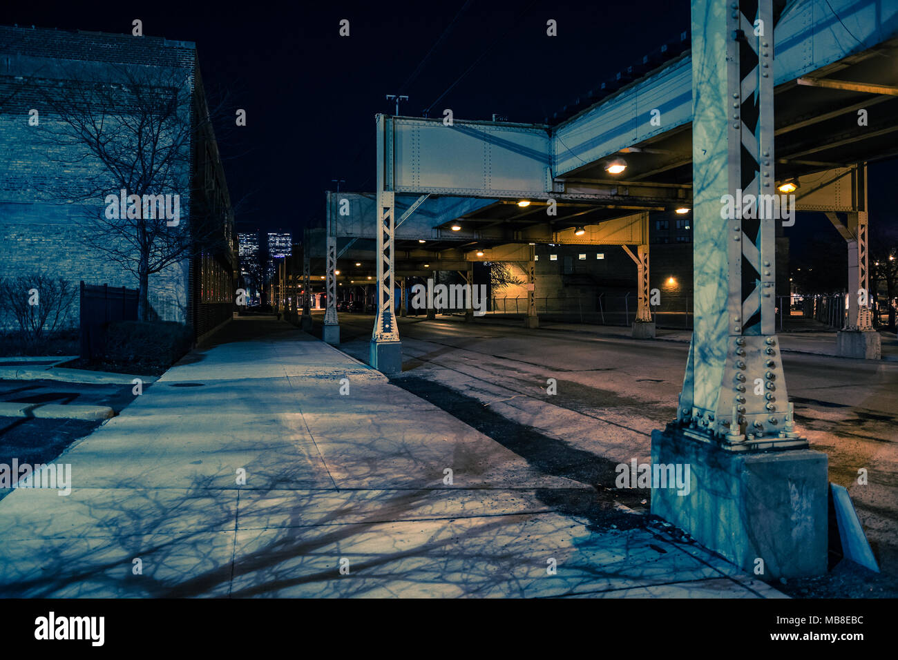 Dark and eerie Chicago urban city street night scenery with elevated ...