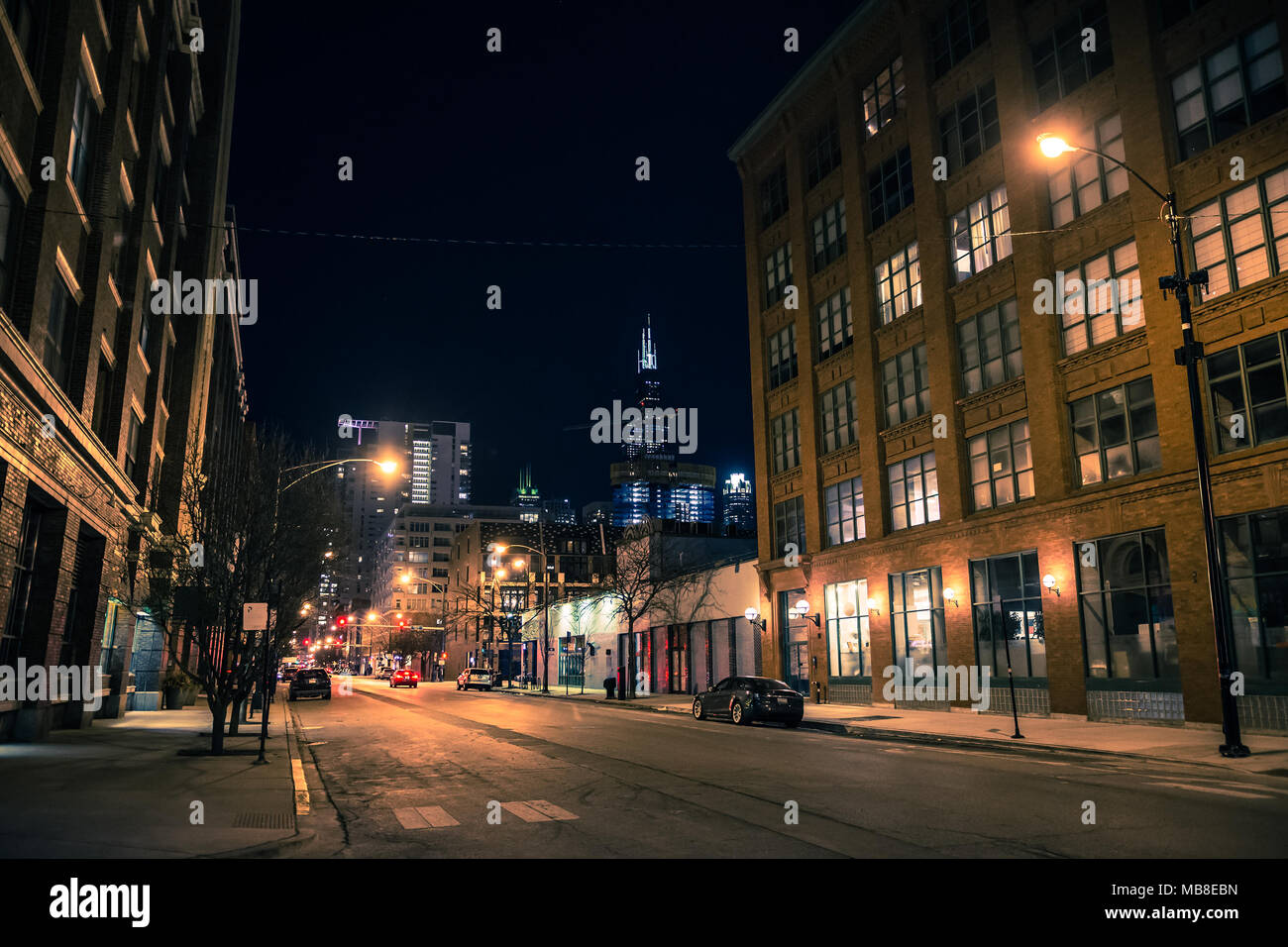 Chicago city street night scene in the West Loop with the skyline and ...