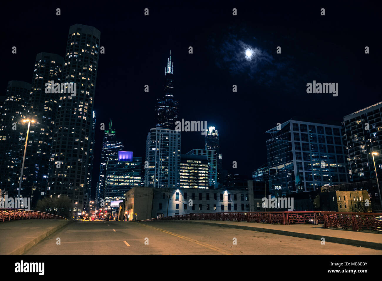 Dark and eerie Chicago city street bridge night scene with the Sears ...