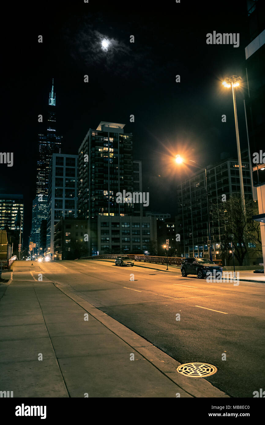 Dark and eerie Chicago city street bridge night scene with the Sears ...