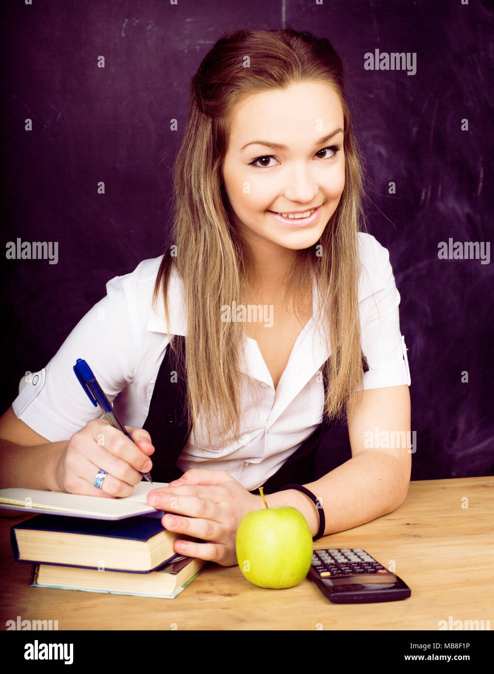 portrait of happy cute student with book in classroom Stock Photo - Alamy