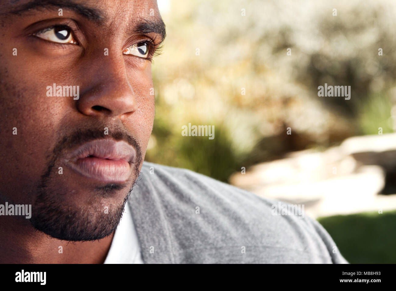 Young African American man looking sad Stock Photo - Alamy
