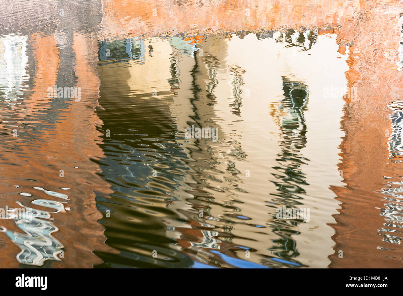 Abstract water reflections of an old red brick building in Worcester ...