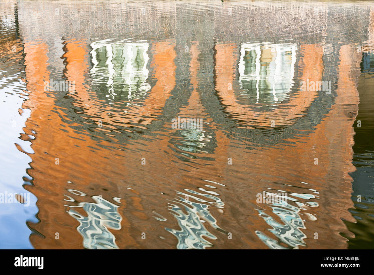 Abstract water reflections of an old red brick building in Worcester ...