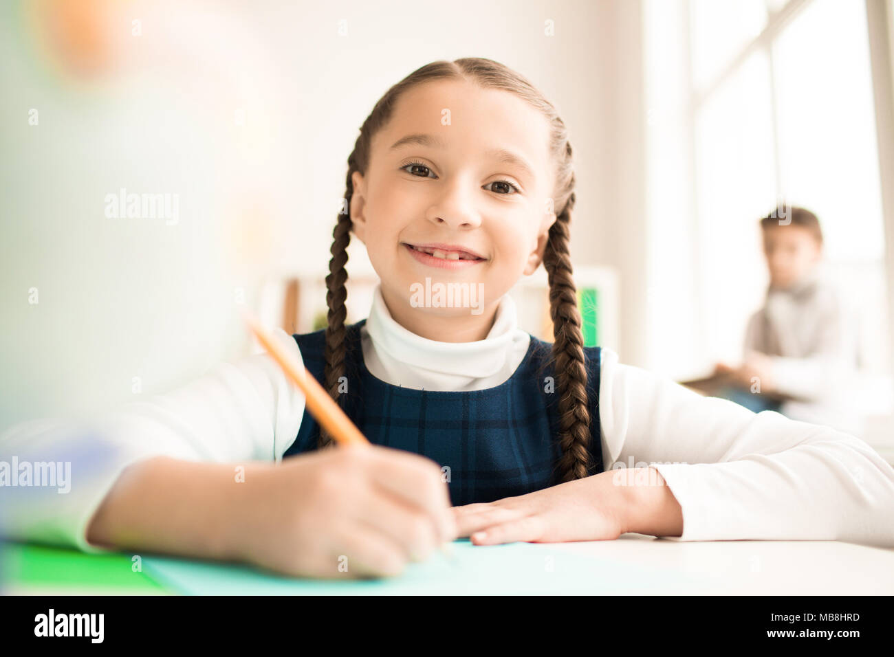 Schoolgirl writing hi-res stock photography and images - Alamy