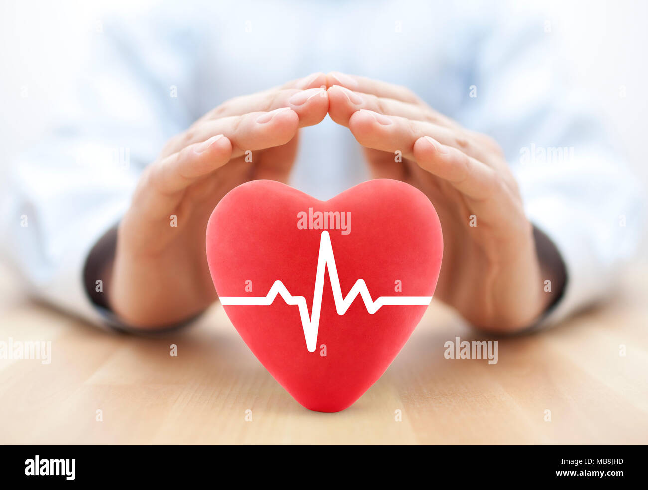 Heart pulse covered by hands. Health insurance concept Stock Photo - Alamy