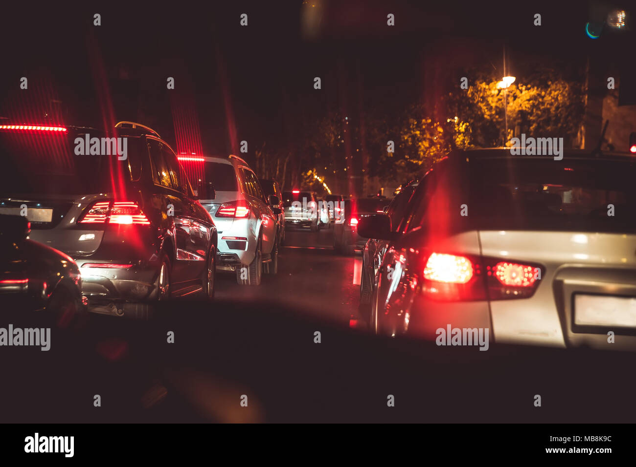 Cars in the night traffic jam . Looking behind the cars. Cars are red ...
