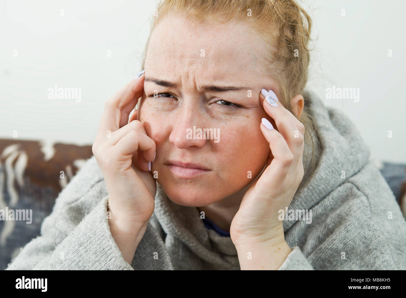 Stressed exhausted young woman having strong tension headache Stock ...