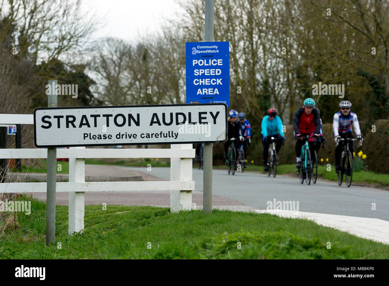 Stratton Audley village sign with cyclists passing, Oxfordshire ...