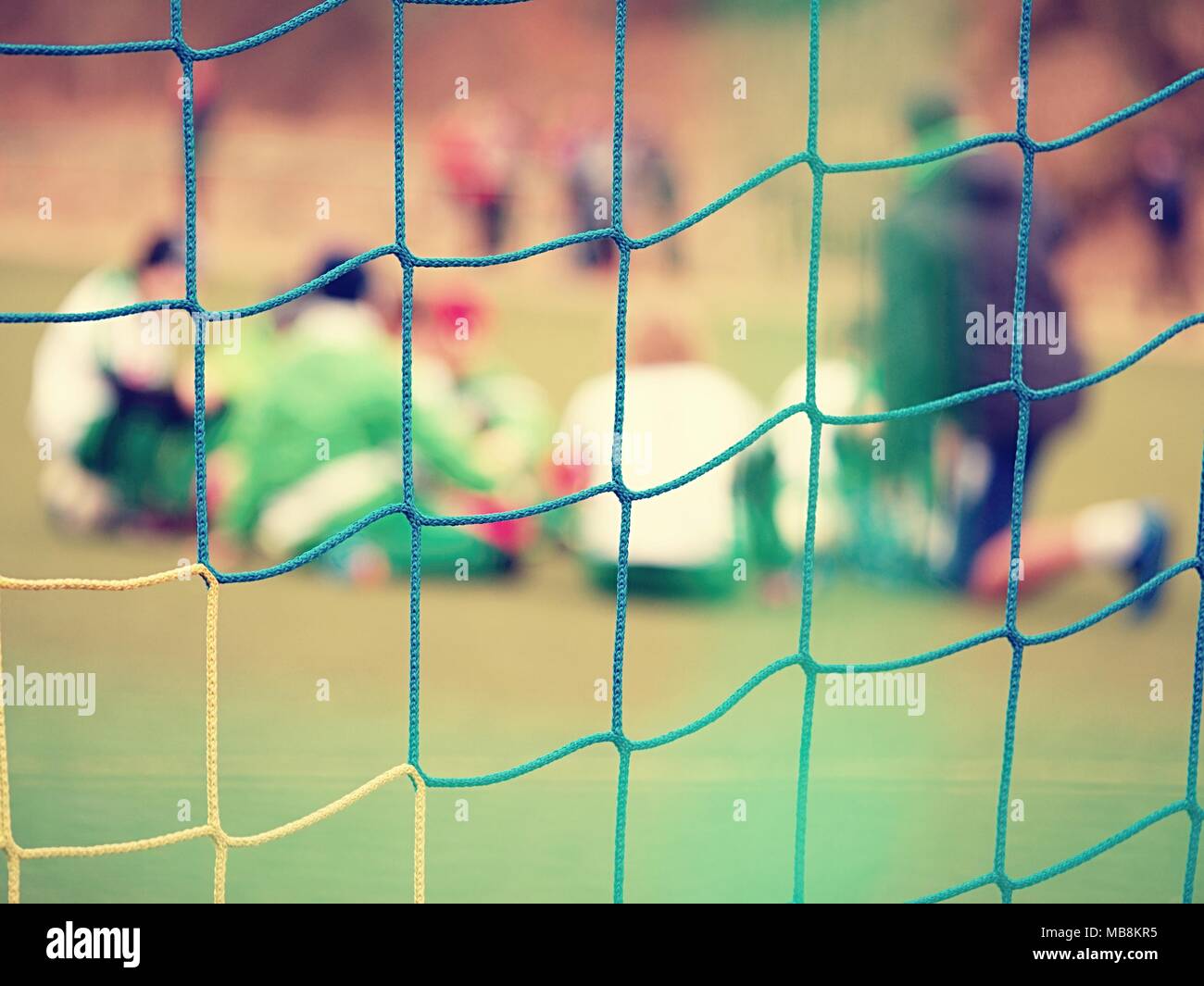 Soccer football net background over green grass and blurry stadium ...