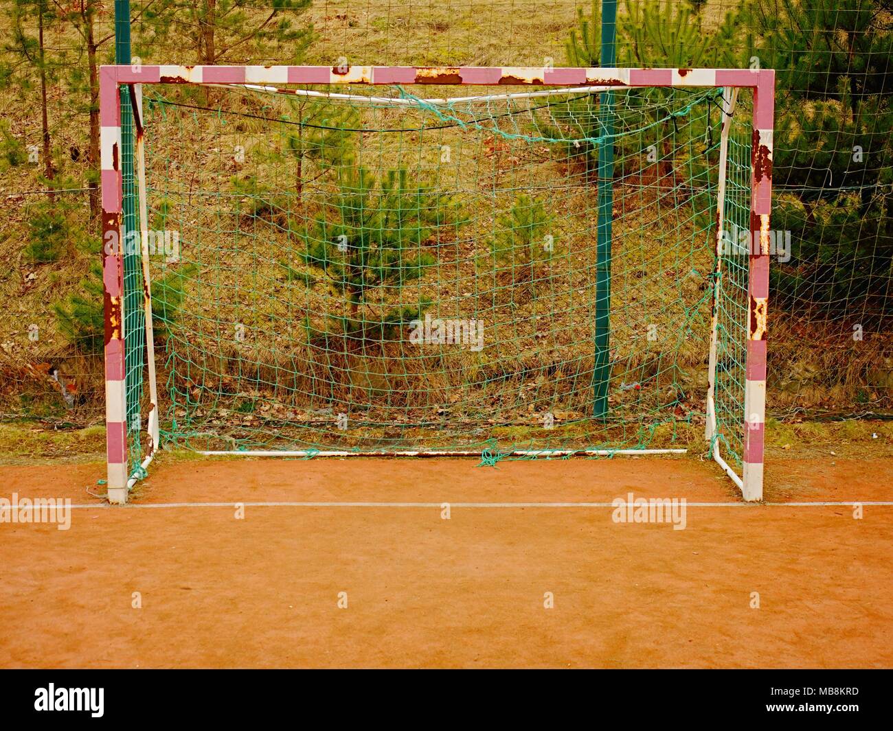 Soccer football net background over green grass and blurry stadium ...