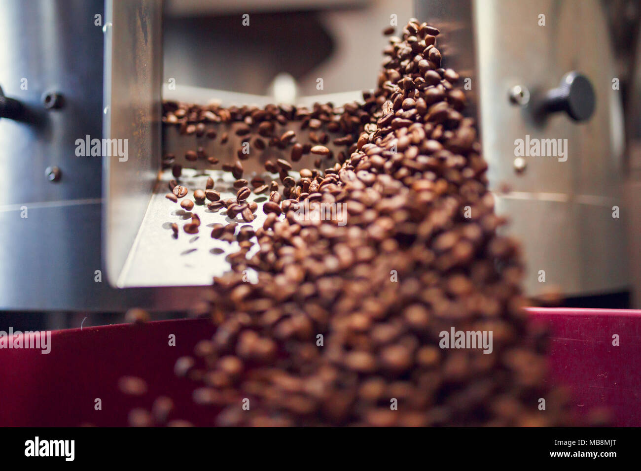 Image of falling coffee beans from roaster close-up Stock Photo - Alamy