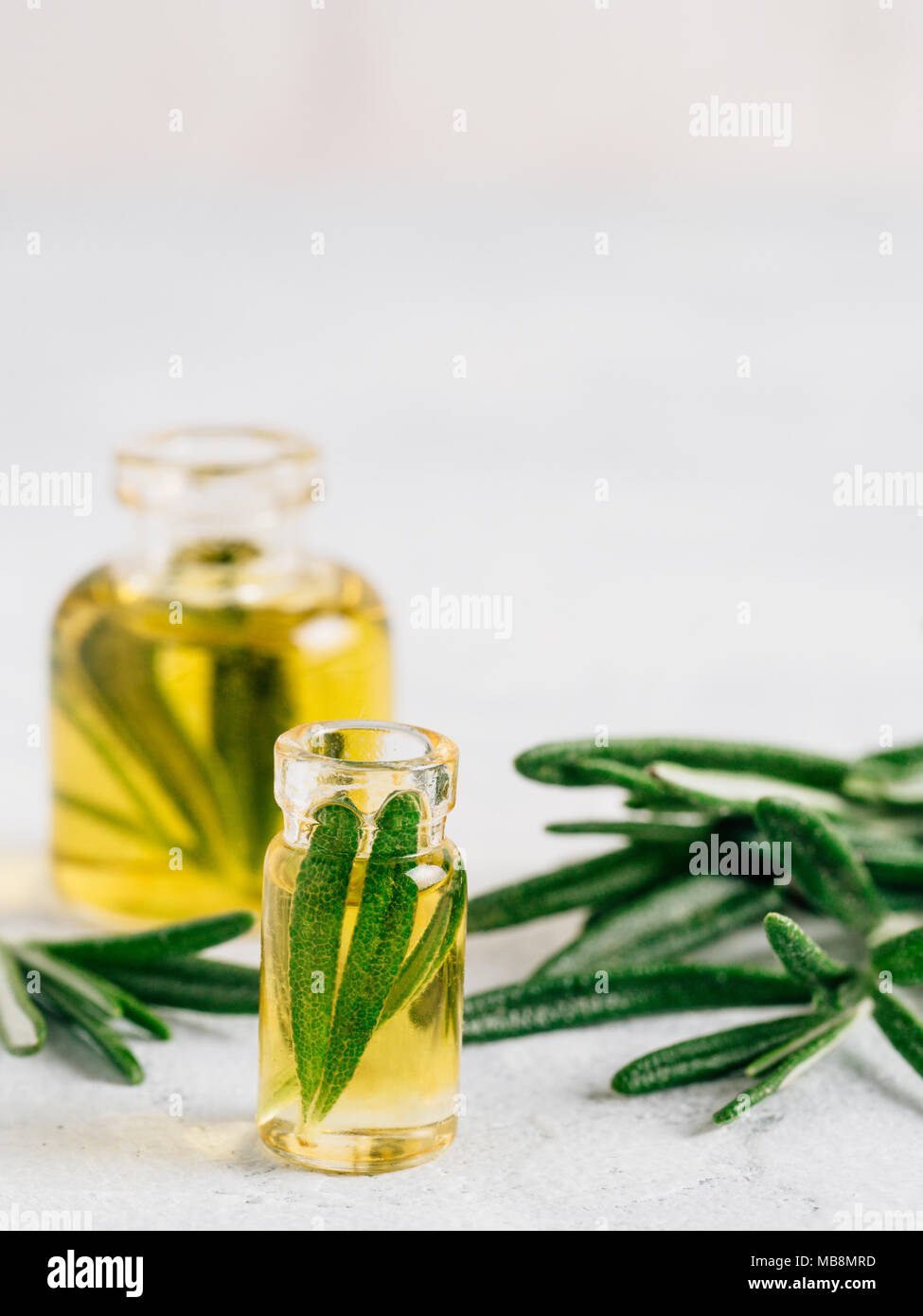 Rosemary oil. Rosemary essential oil oil in small glass bottle and ...