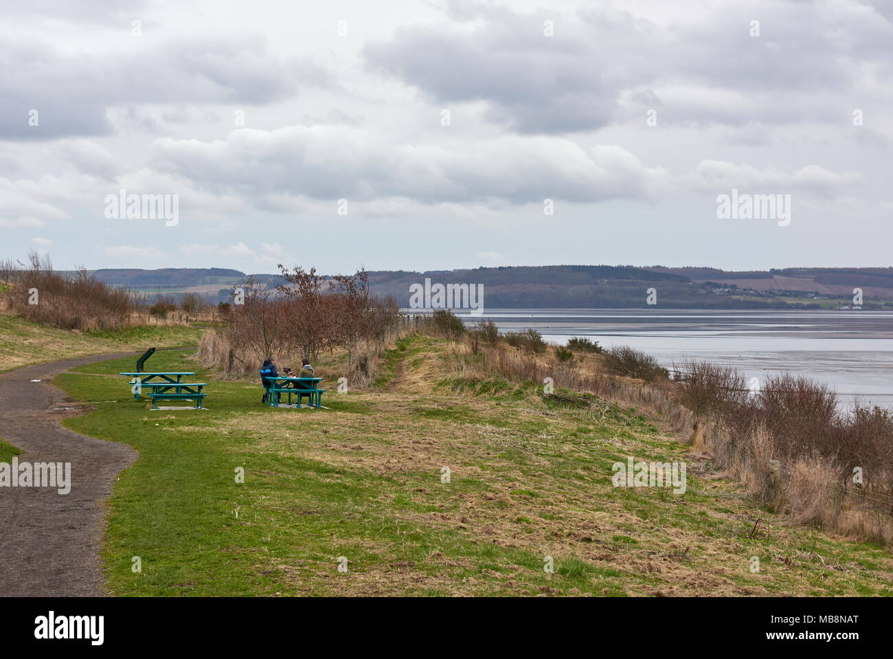A Couple and their Dog taking a rest at one of the Picnic Tables in the ...