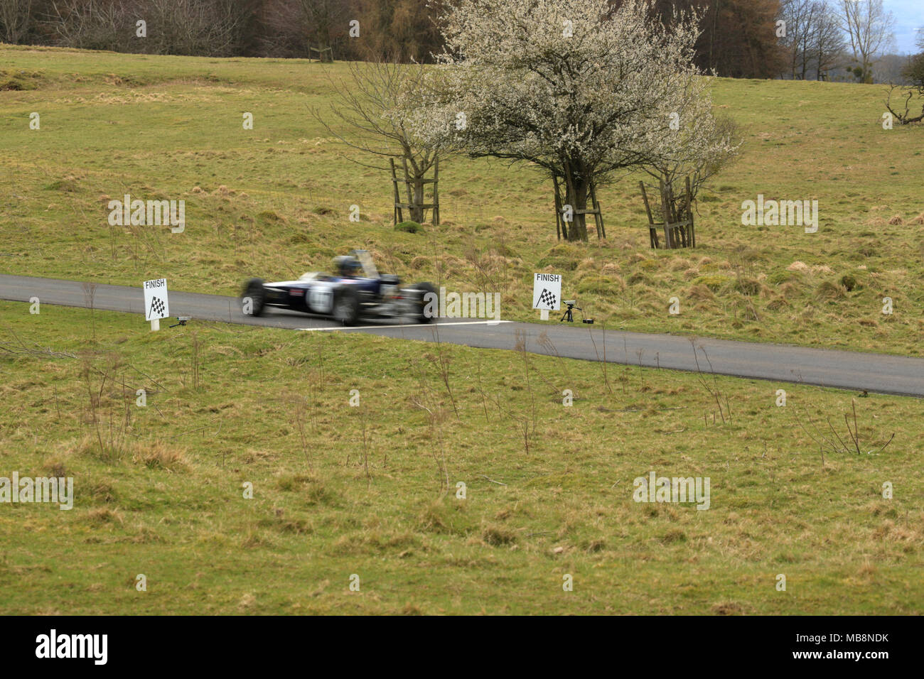 A racing car crossing the finish line at Loton park hill climb ...