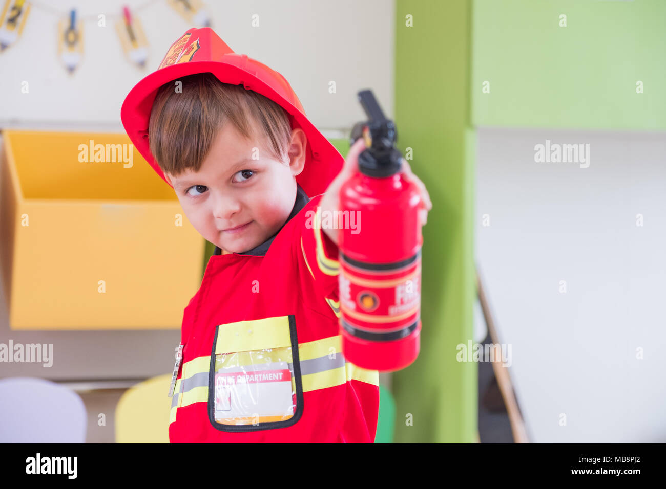 Caucasian boy kid dress up to fireman and use speaker at roll play ...