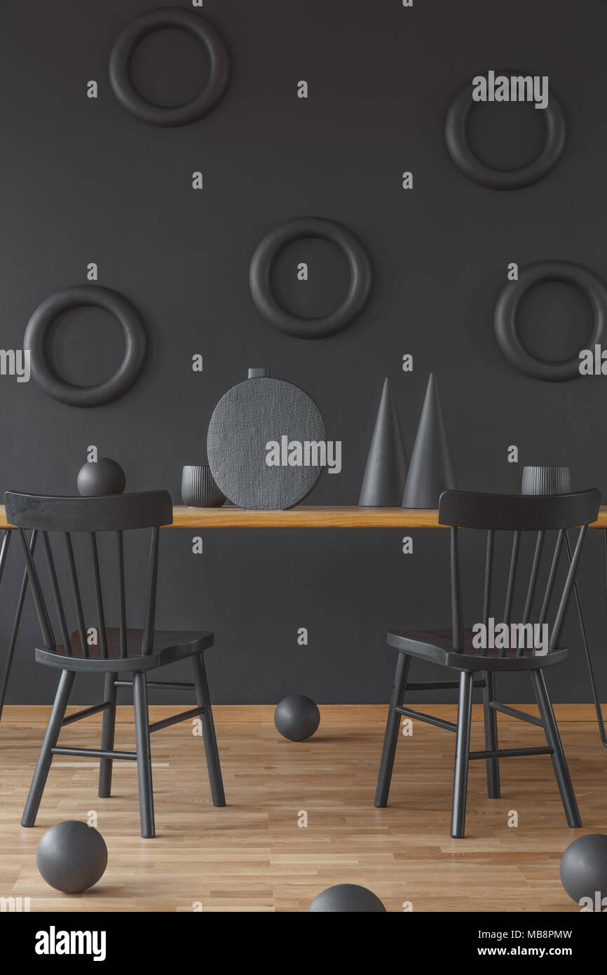 Wooden sculptures in round and cone shapes placed on the floor and ...